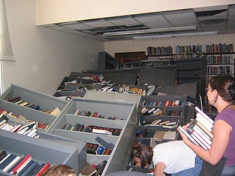 Library bookcases tumbled like dominos - Boing Boing